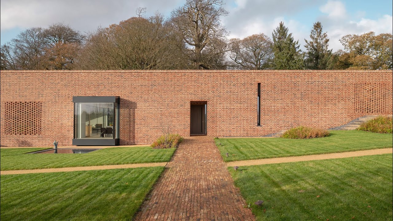 Linear brick wall conceals earthy and tactile interiors of Devon ...